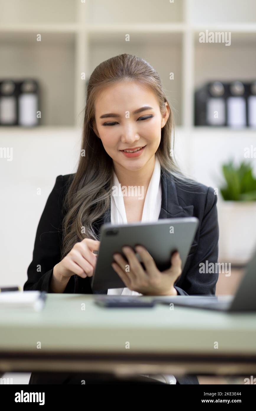 Portrait, Professional and gorgeous millennial Asian businesswoman reading something on her ...
