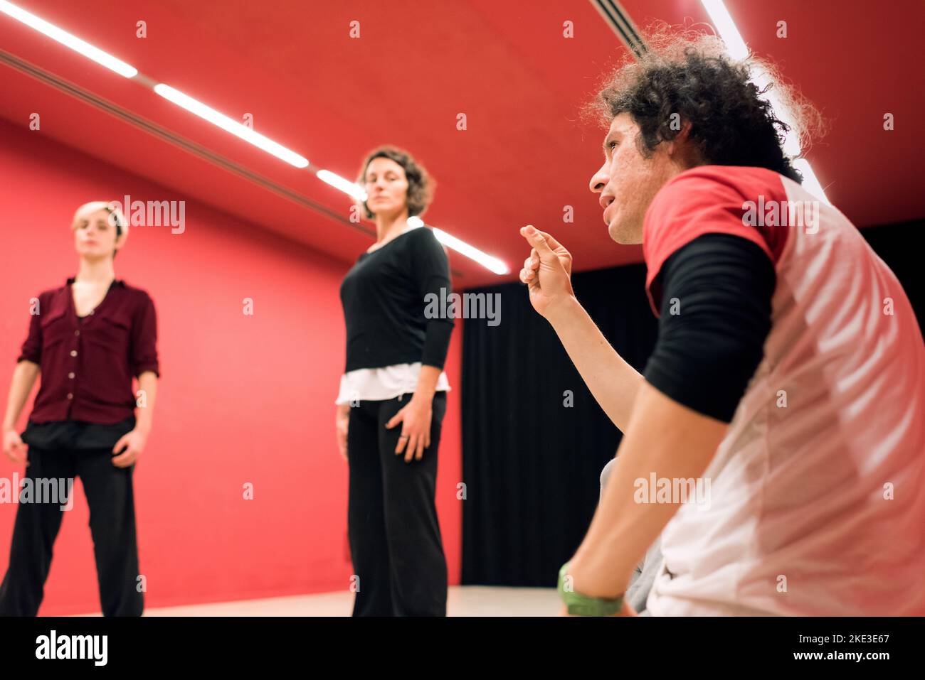 theater students receiving instructions from their teacher during an ...