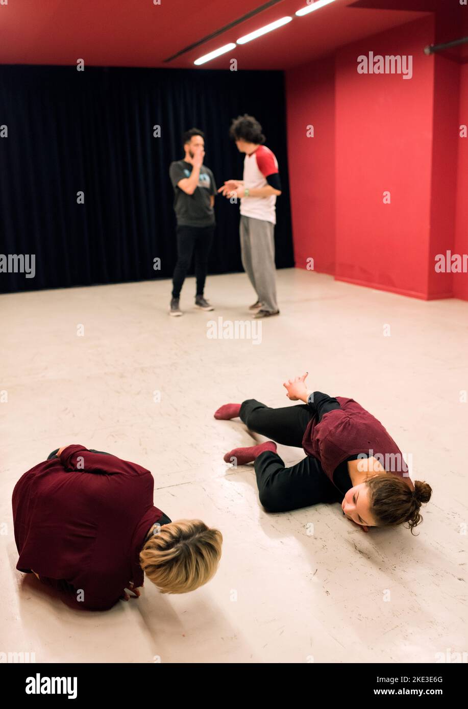 4 theater students in class: two standing and two reclining Stock Photo ...