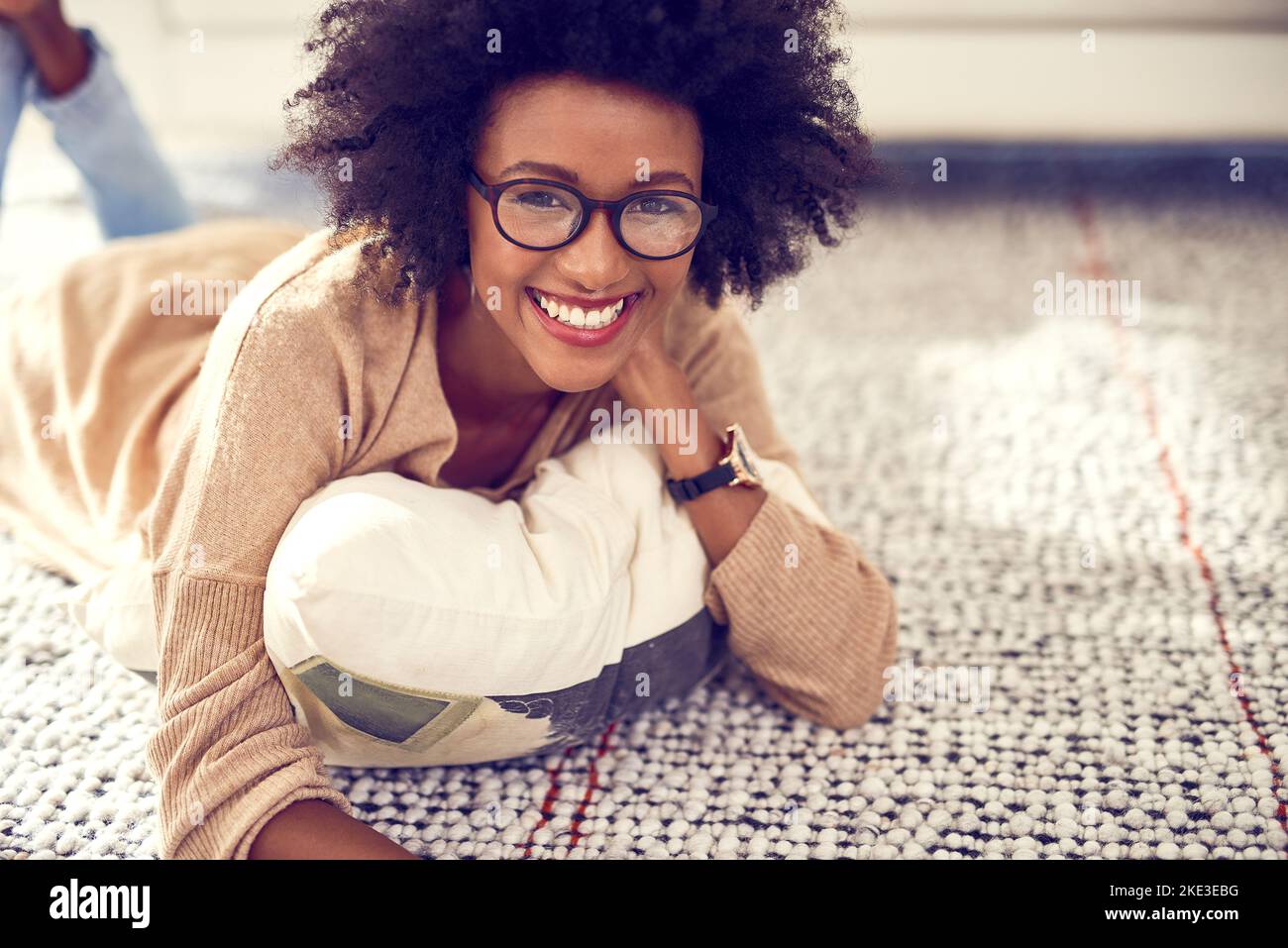 Happiness lives here. Portrait of a happy young woman relaxing at home ...