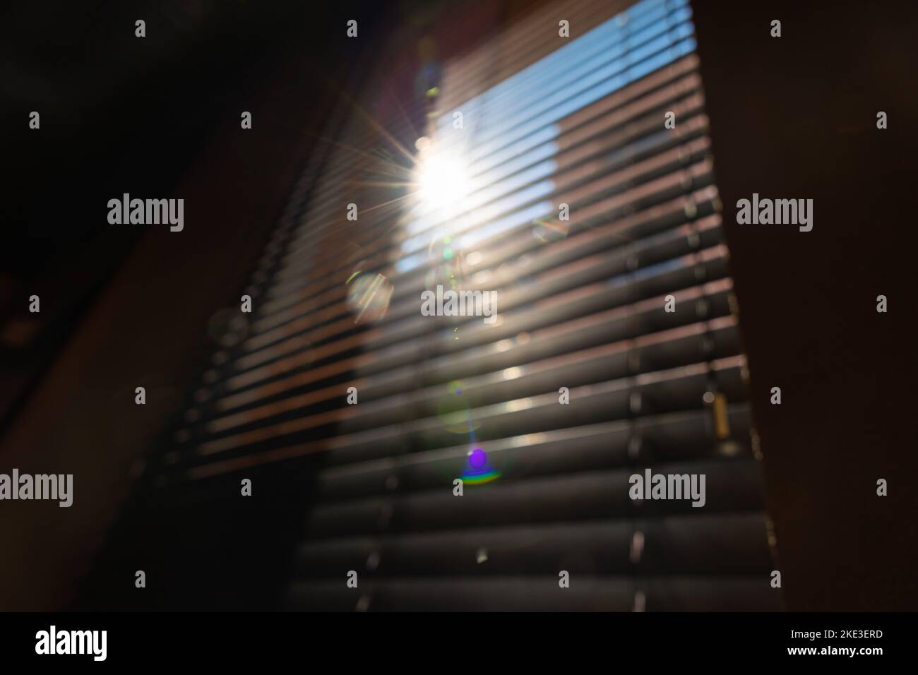 Window blinds blurry photo. Defocused jalousies with direct sunlight ...
