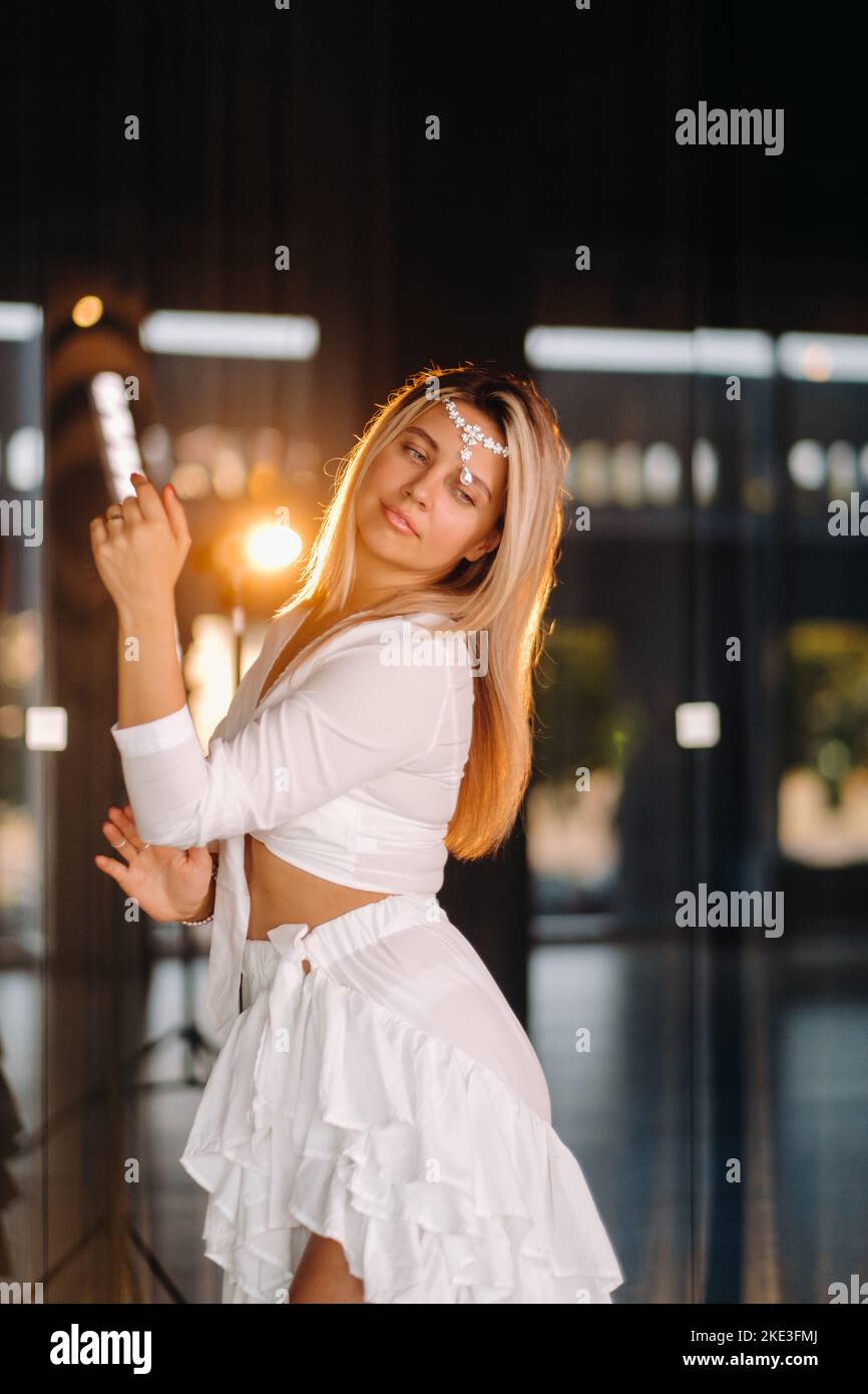 Beautiful smiling girl in a white dress dancing in the gym Stock Photo ...
