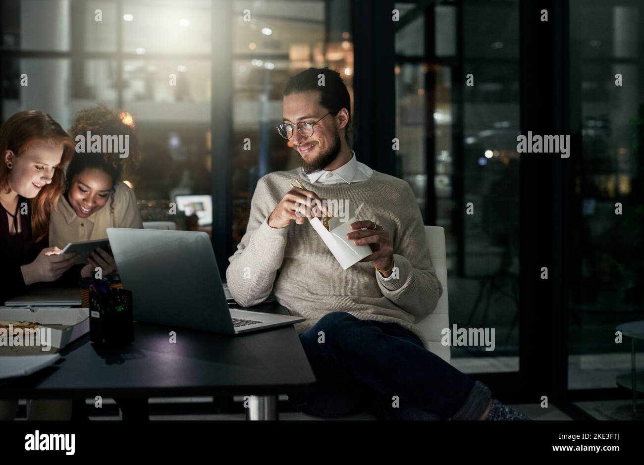 Forget the time, beat the deadline. a group of young designers working ...