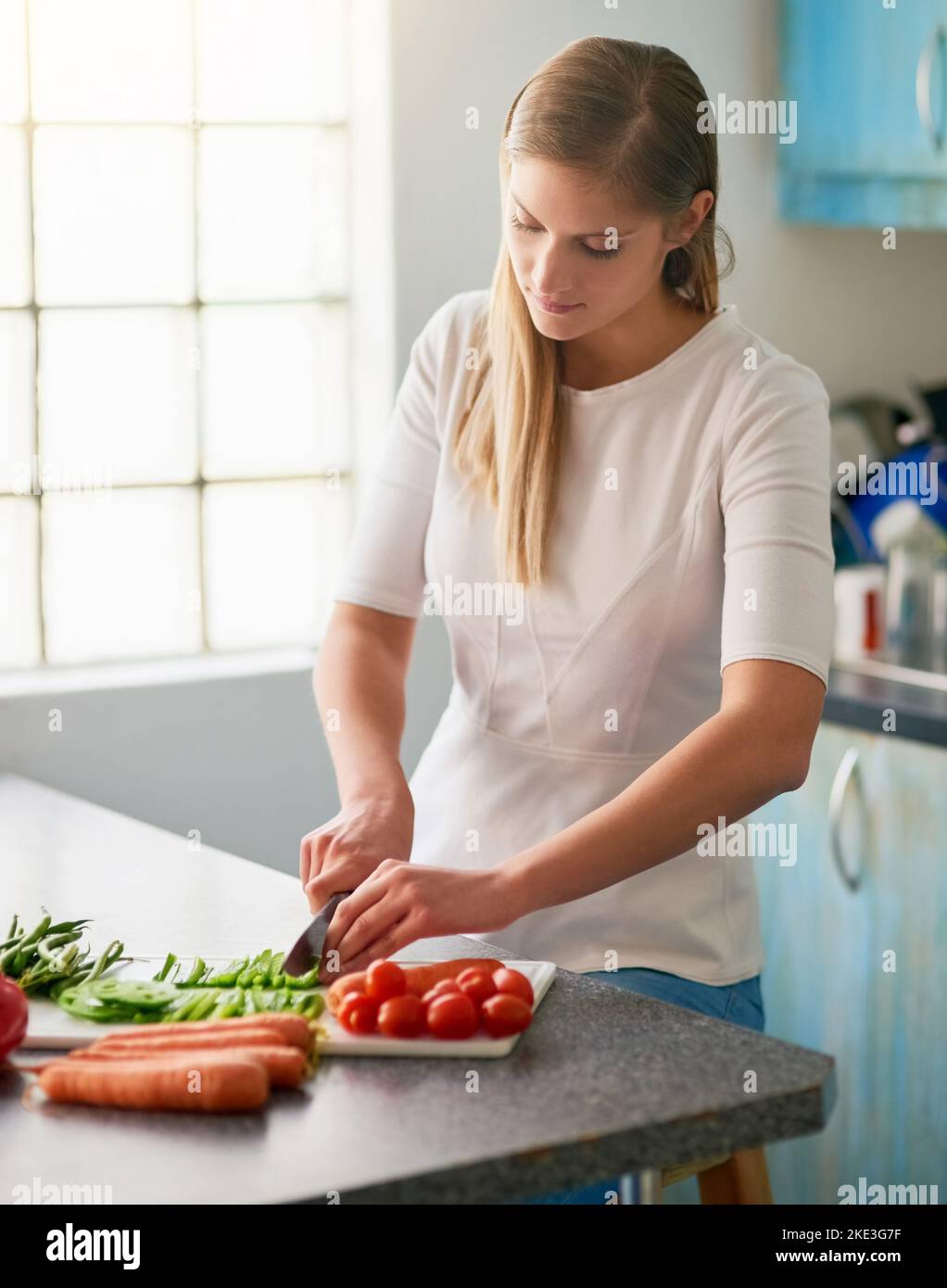 Lunch done the healthy way. a young woman preparing a healthy meal at ...