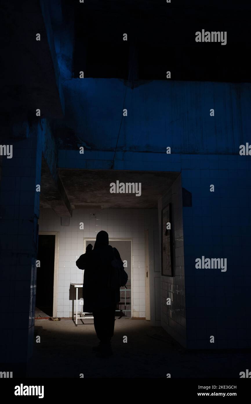 silhouette of a stalker in a hood from the back against the background ...