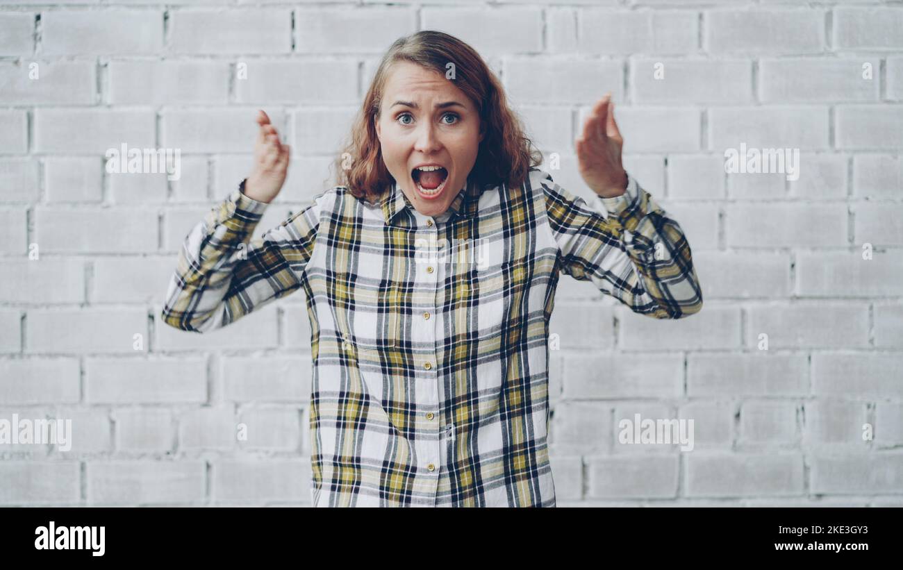 Portrait of stressed young woman screaming and gesturing expressing ...