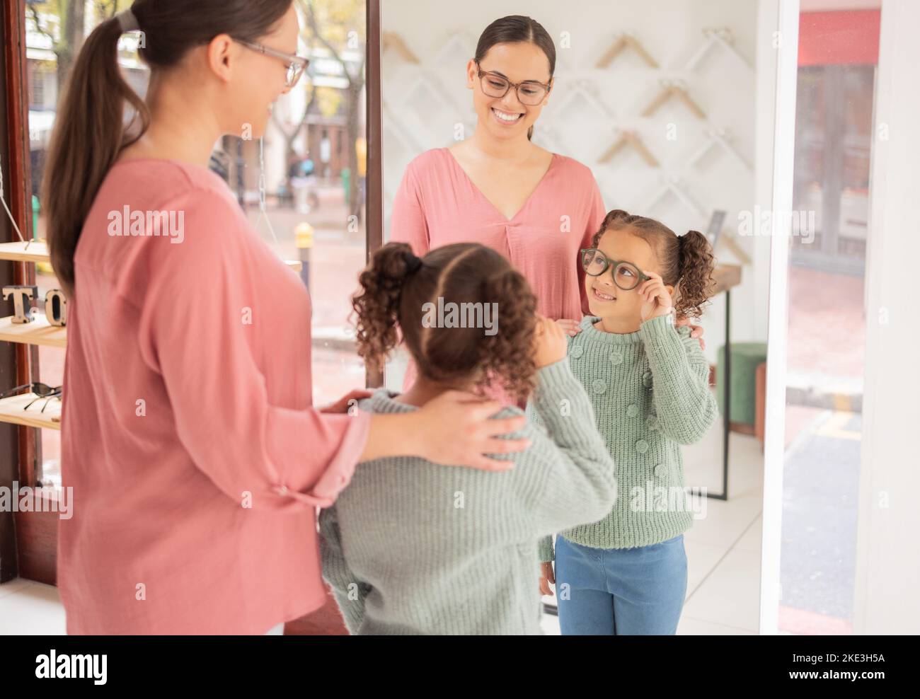Retail, eye care and mother and daughter shopping for glasses at ...