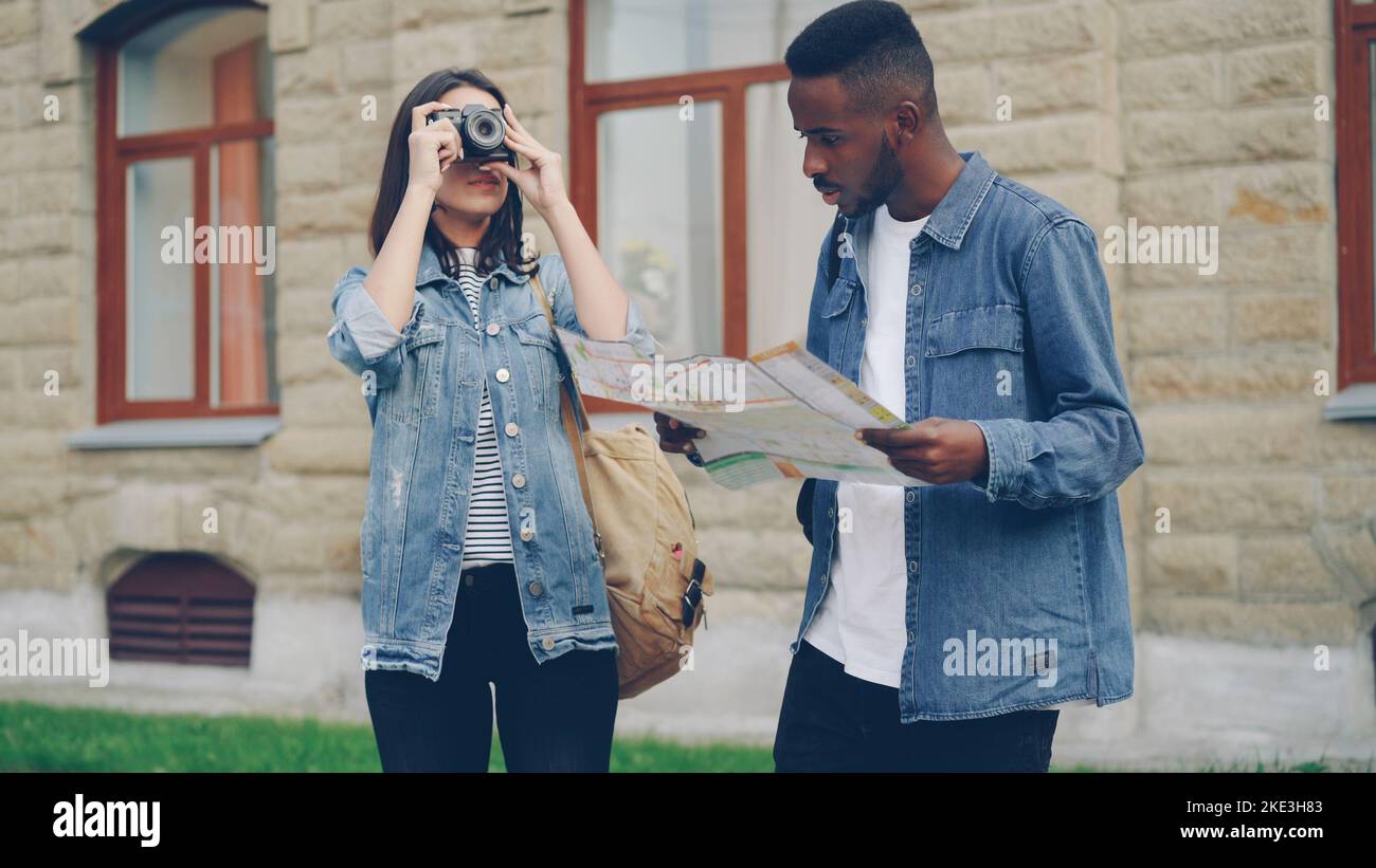 Handsome African American man traveler is looking at map when his ...