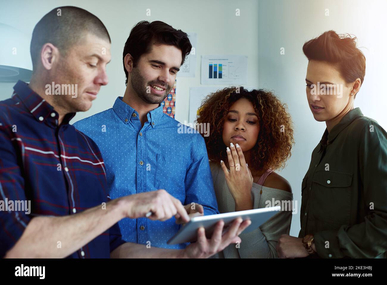 Giving his honest opinion. a group of coworkers discussing something on ...