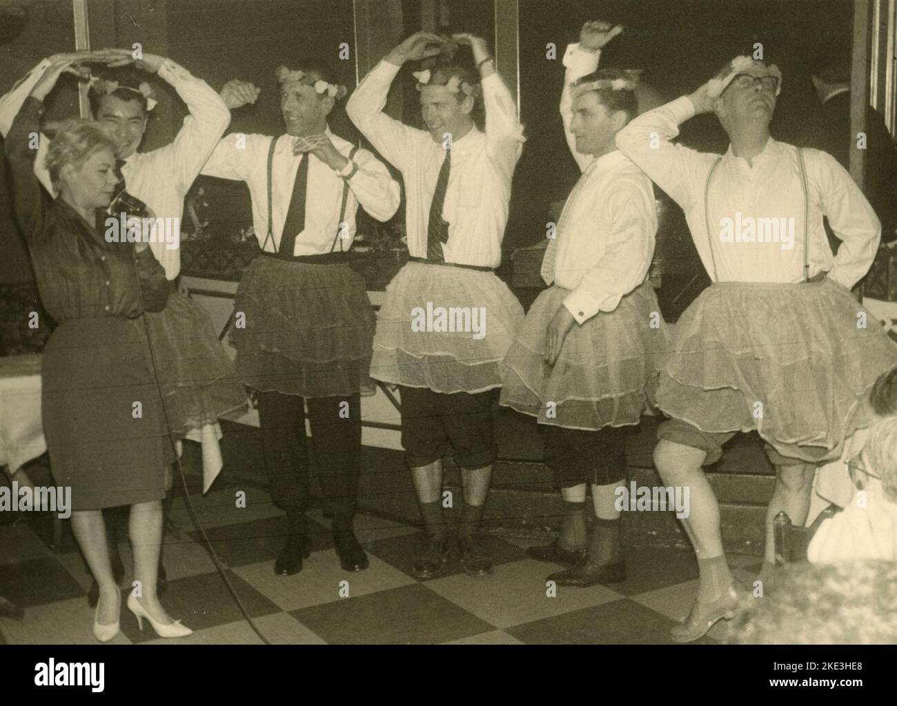 Group of men dancing with the ballet tutu and flowers crown, France ...