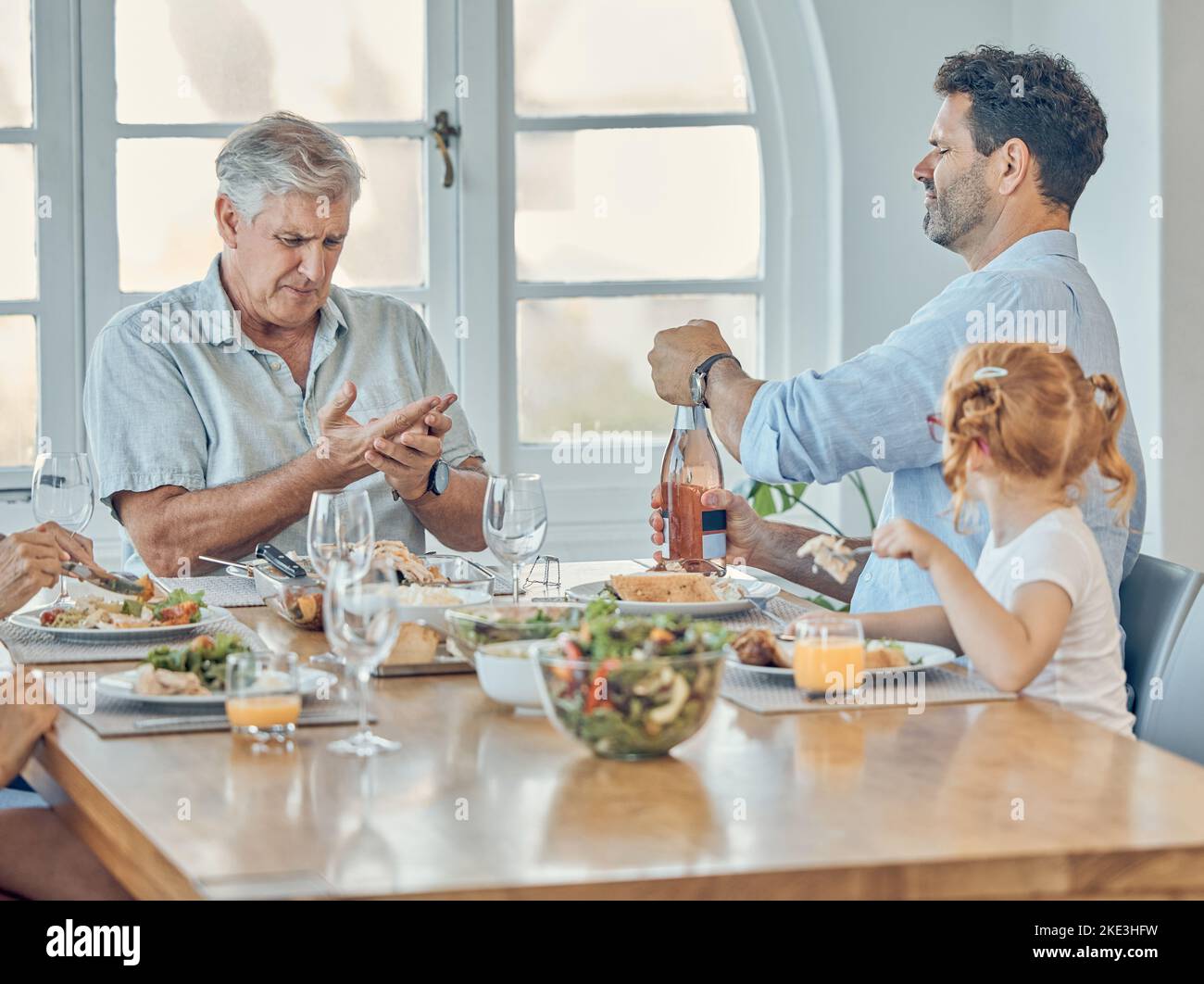 Lunch, dining room and family eating together in celebration at a ...