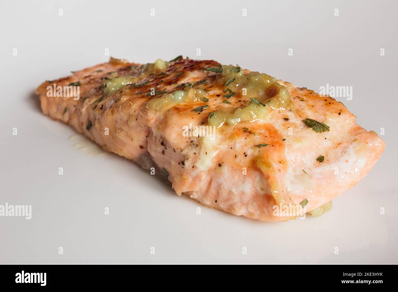 Close-up of a lemon salmon loin with garlic and parsley on an elegant ...