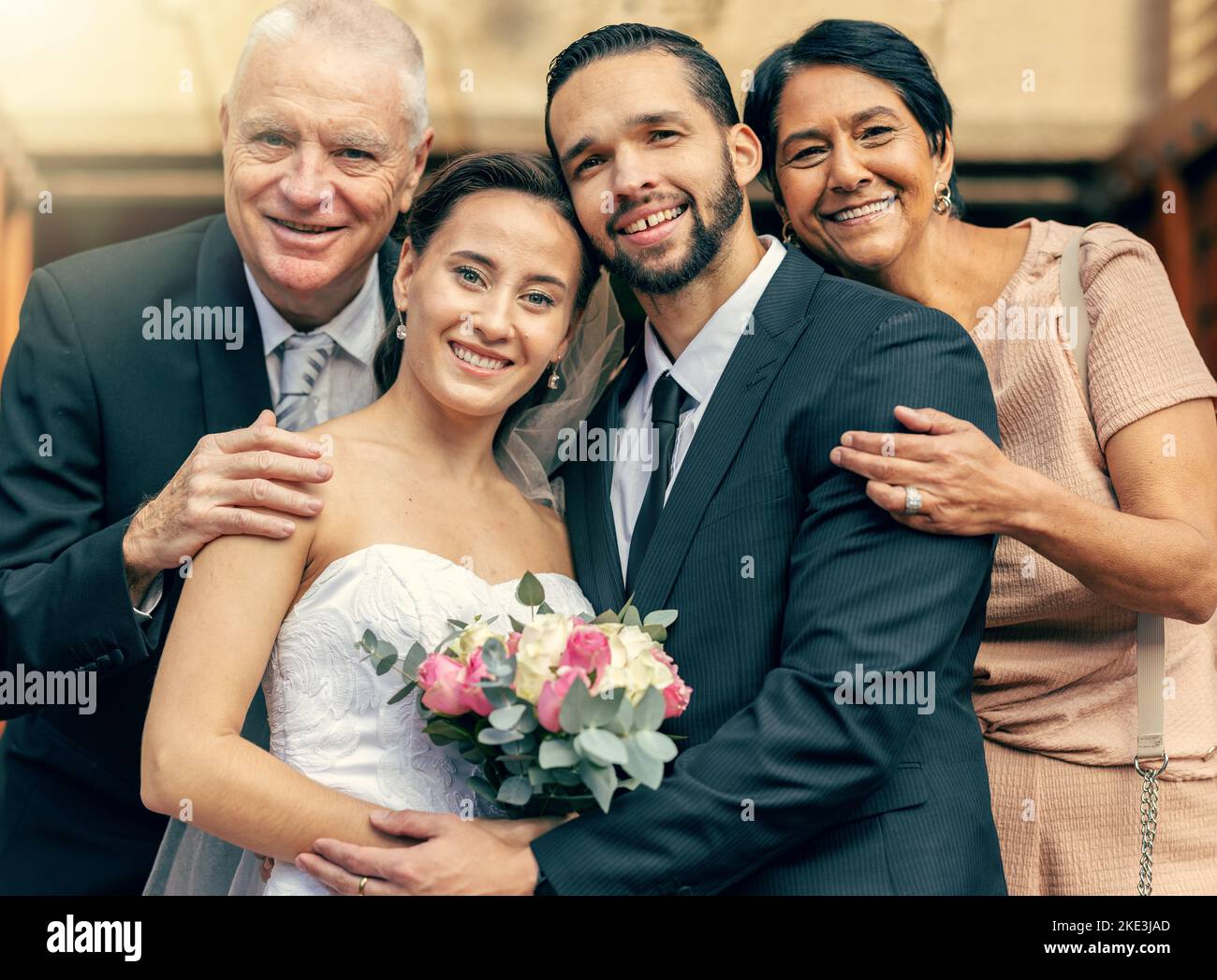 Bride, groom and family portrait hug for wedding celebration ...