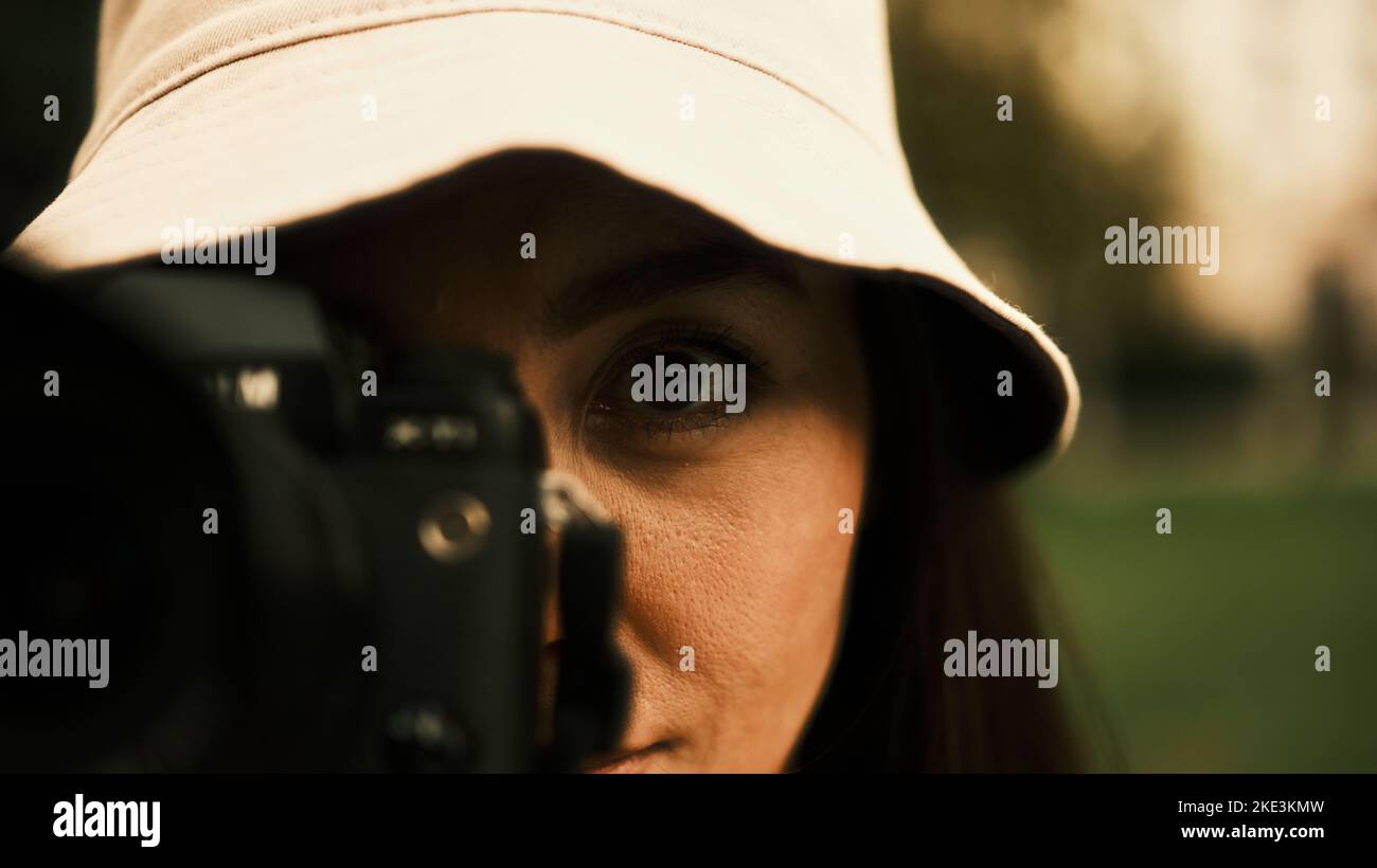 The girl looks into the camera lens with one eye Stock Photo - Alamy