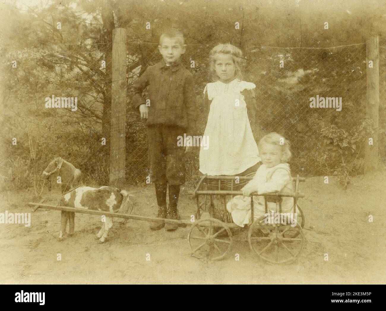 Children playing with toy carriage, 1880s Stock Photo - Alamy
