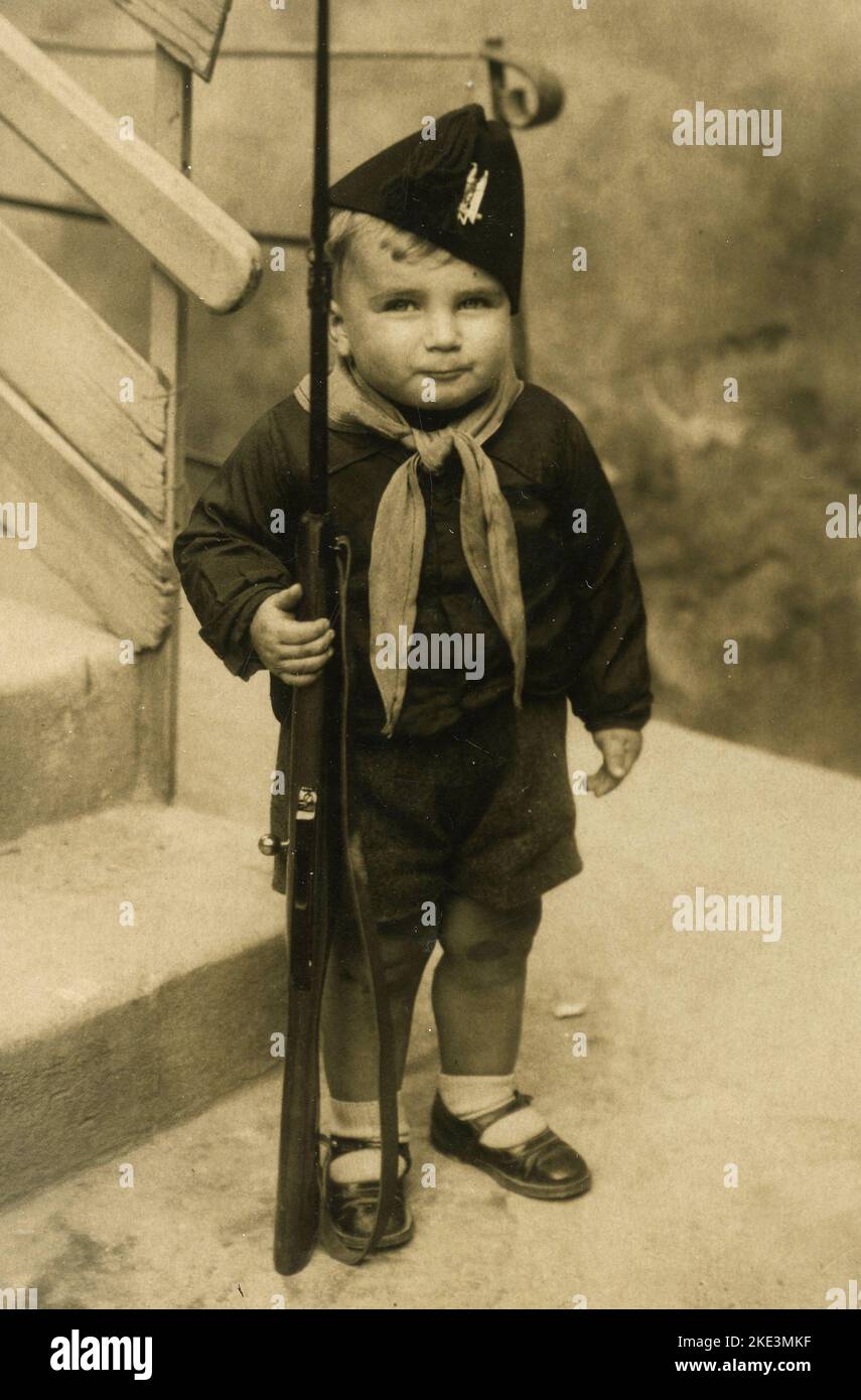 Little boy with musket in the fascist uniform of Figlio della Lupa or ...