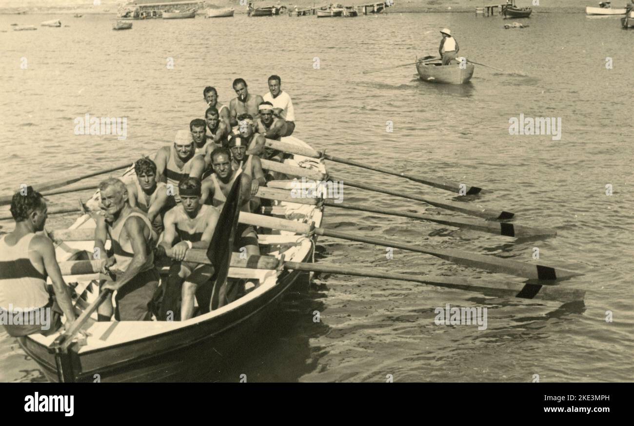 Rowers of the Ardenza on a boat for the rowing competition Palio ...