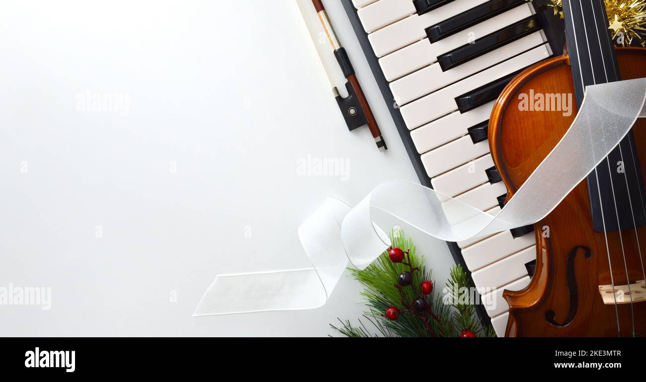 Christmas musical event concept background with piano and violin on ...