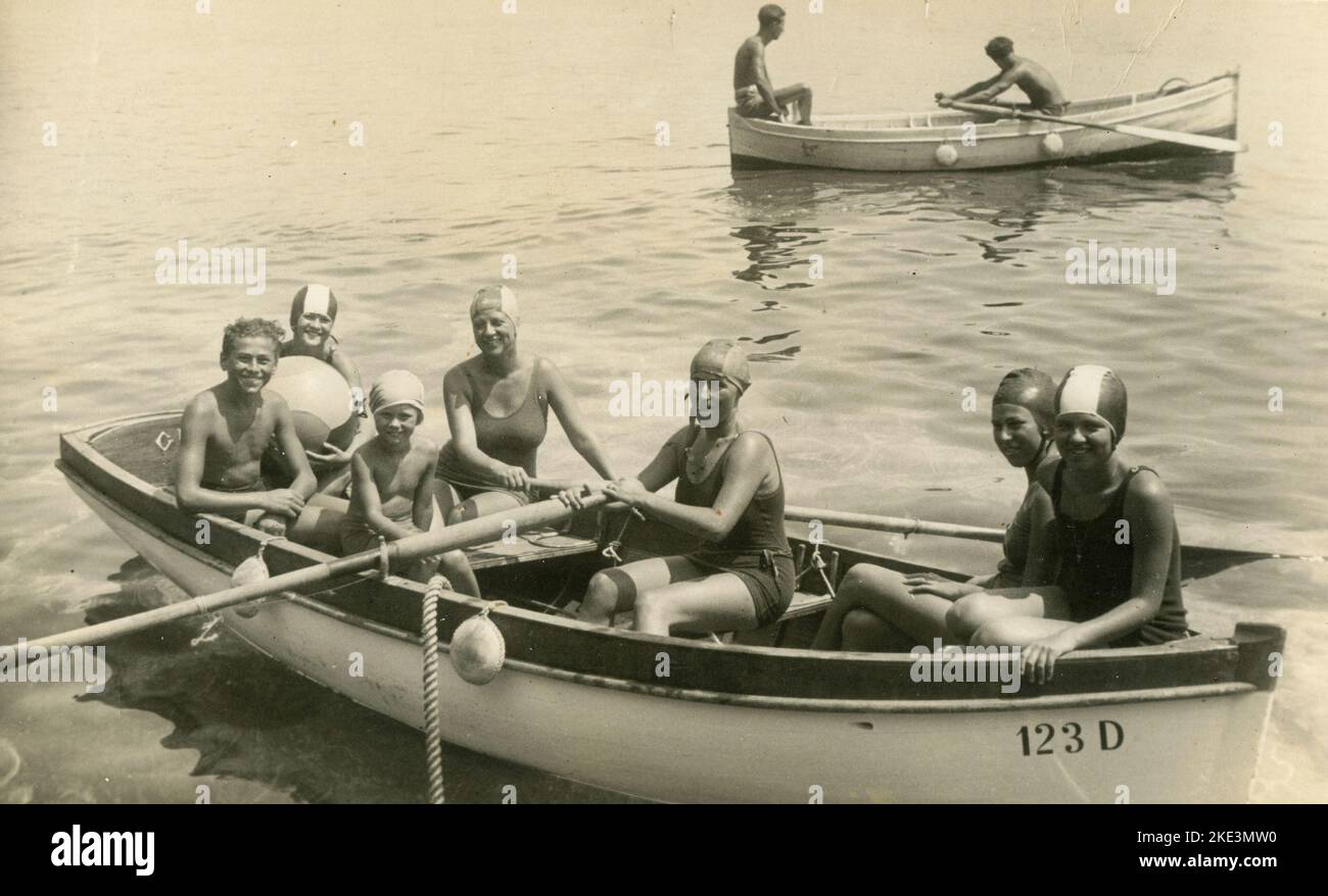 Family group on a small rowing boat at sea, Italy 1930s Stock Photo - Alamy