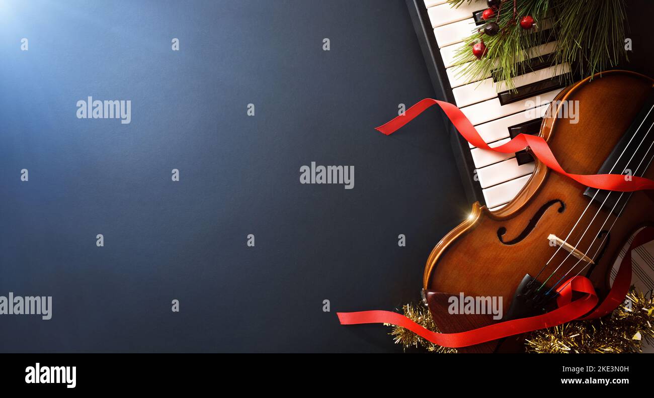 Christmas musical event concept background with piano and violin on ...