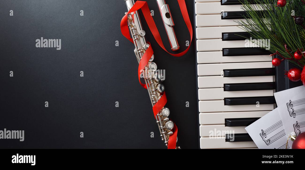 Christmas musical concert concept with piano and transverse flute with ...