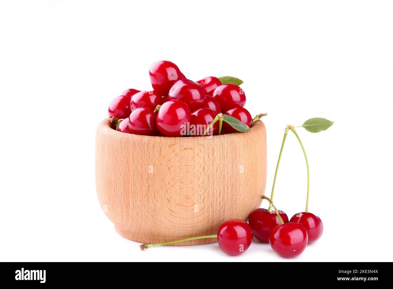 Fresh red cherry fruit in wooden bowl isolated on white background ...