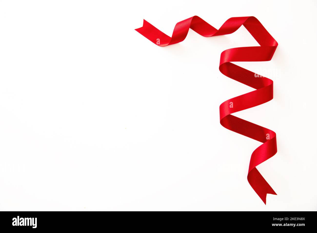 Red ribbon corner isolated on white background, copy space. Christmas ...