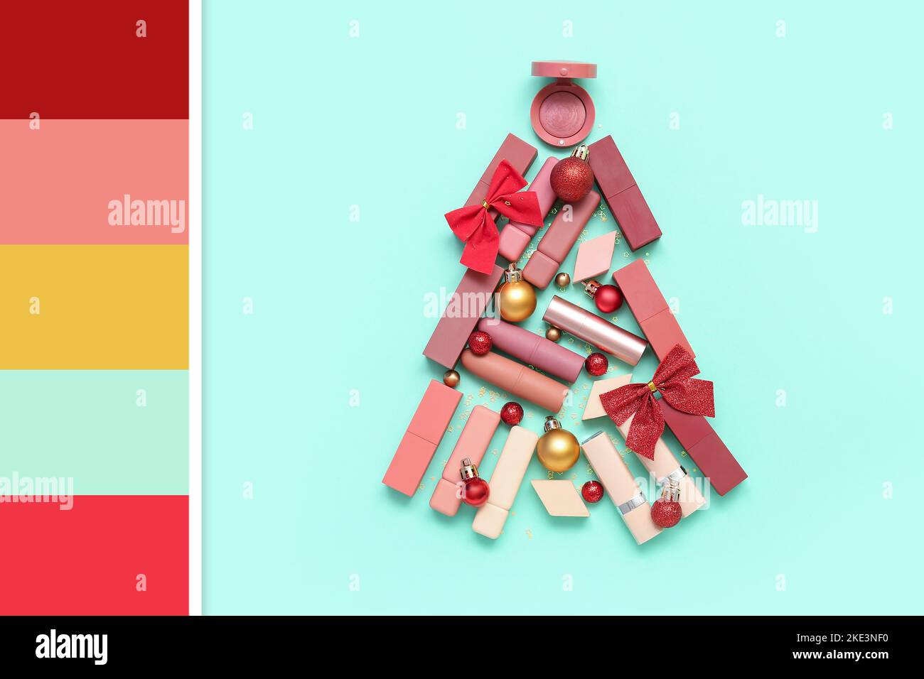 Christmas tree made of lipsticks and Christmas balls on turquoise ...