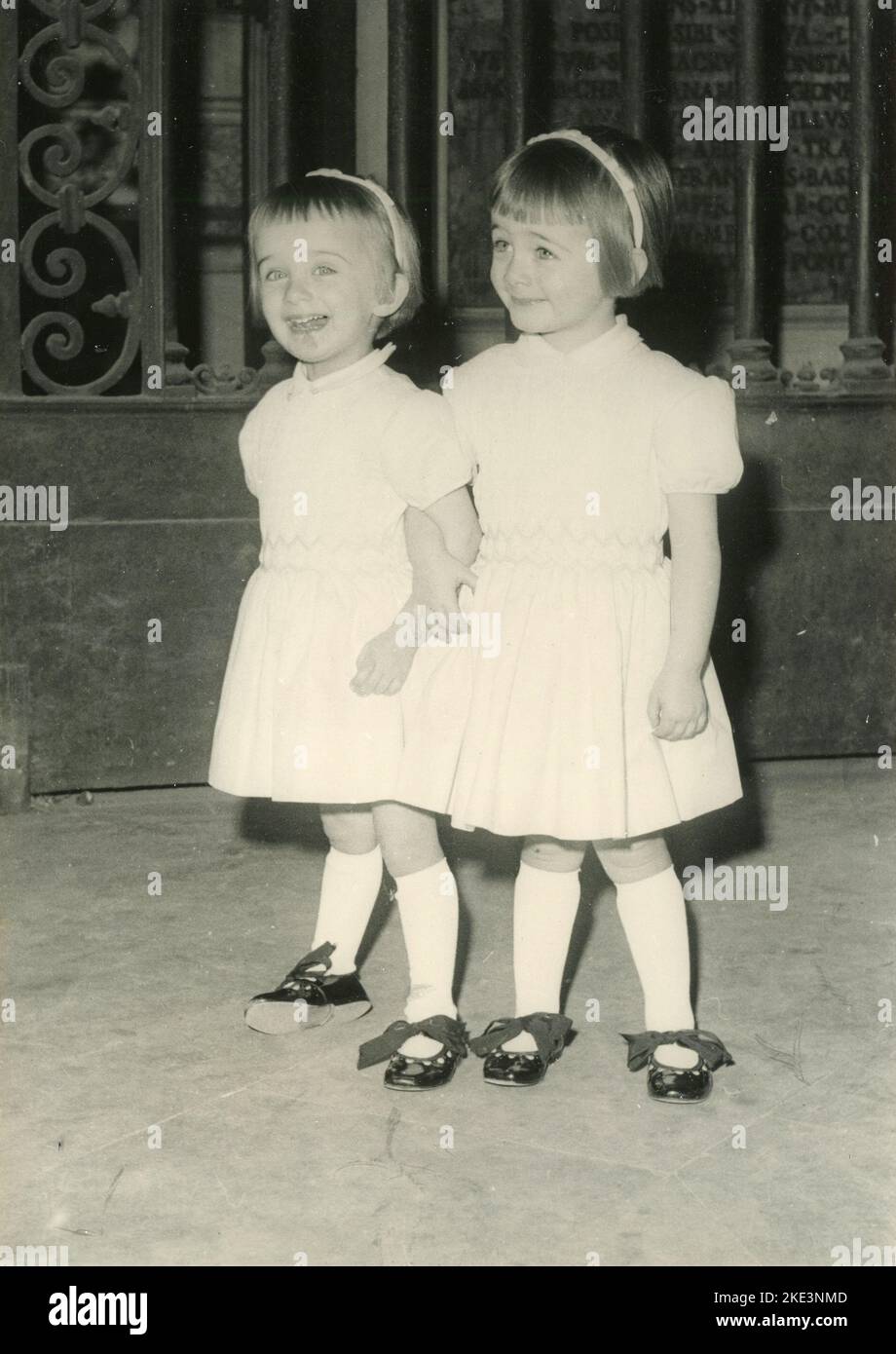 Two children girls dressed alike in white, Italy 1966 Stock Photo - Alamy