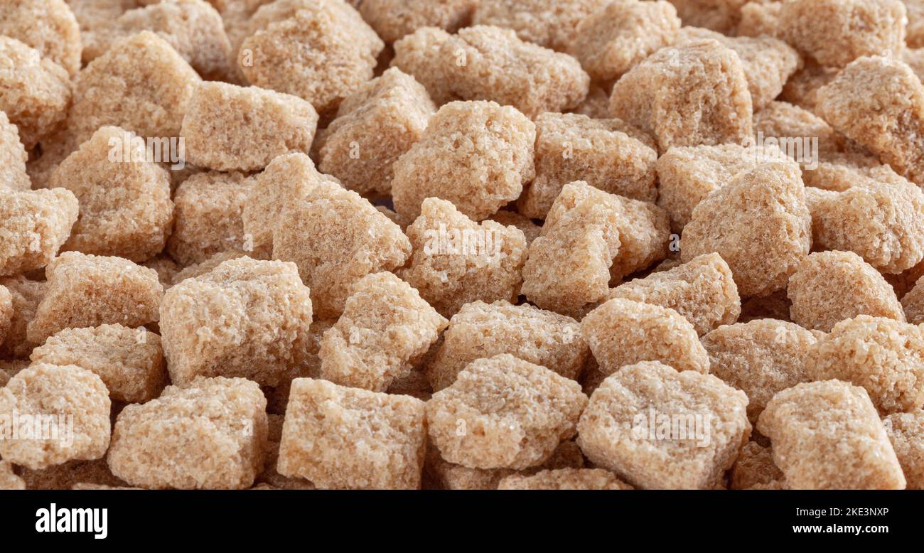 Cubes of brown cane sugar background Stock Photo - Alamy
