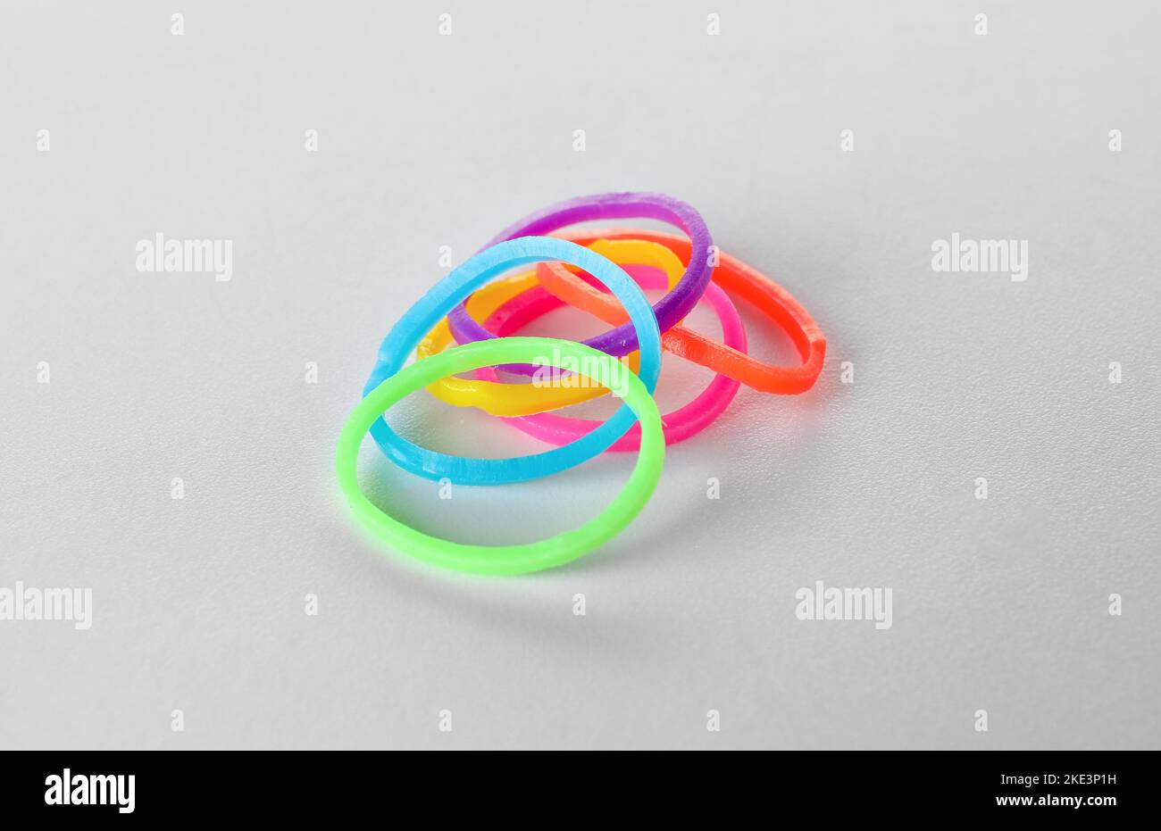 Colorful office rubber bands on white background Stock Photo - Alamy