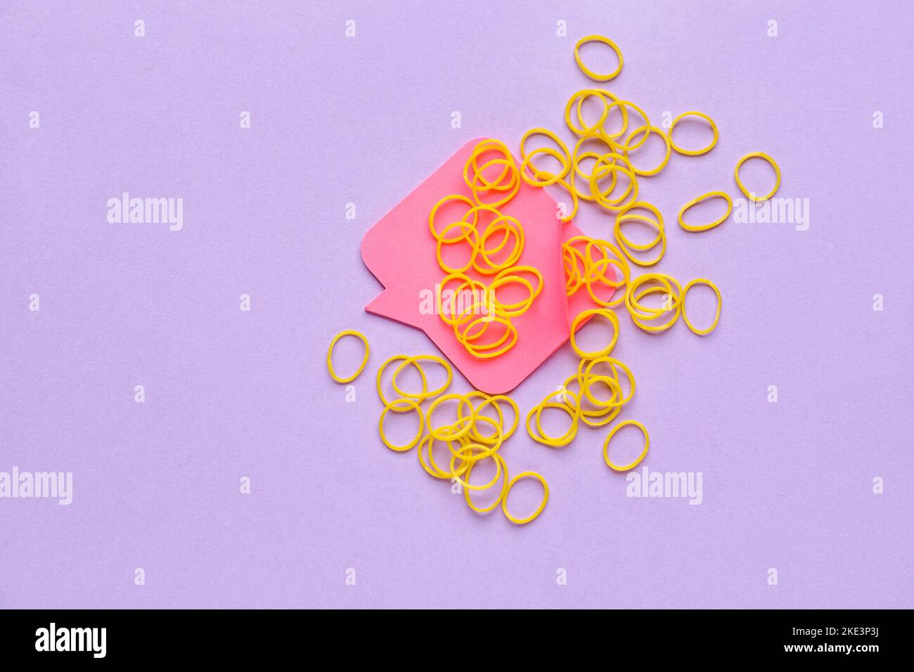 Sticky notes and office rubber bands on lilac background Stock Photo ...