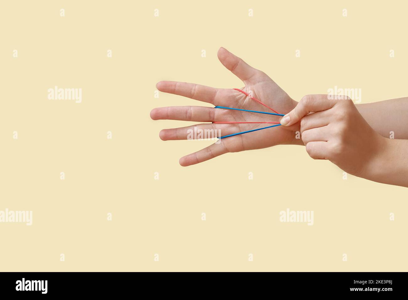 Woman with rubber bands on beige background Stock Photo - Alamy