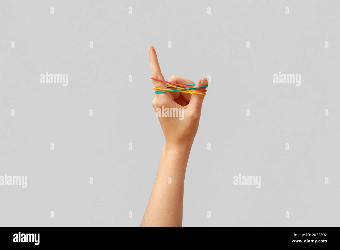 Woman with rubber bands on grey background Stock Photo - Alamy