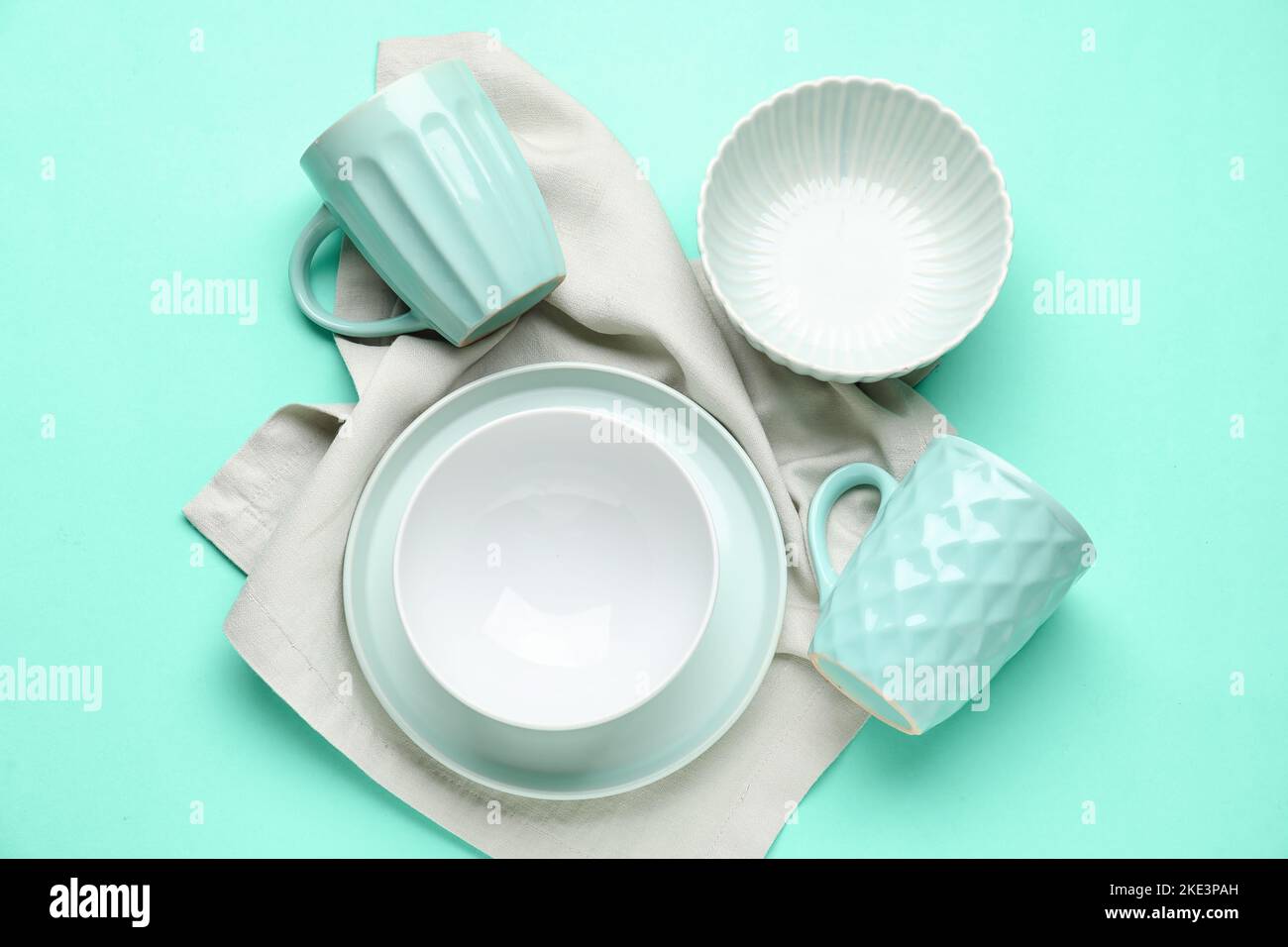 Set of beautiful dinnerware on mint background Stock Photo - Alamy