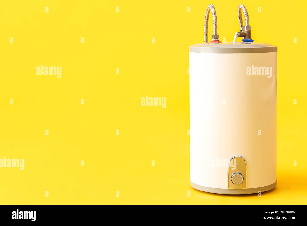 Modern electric boiler on yellow background Stock Photo - Alamy