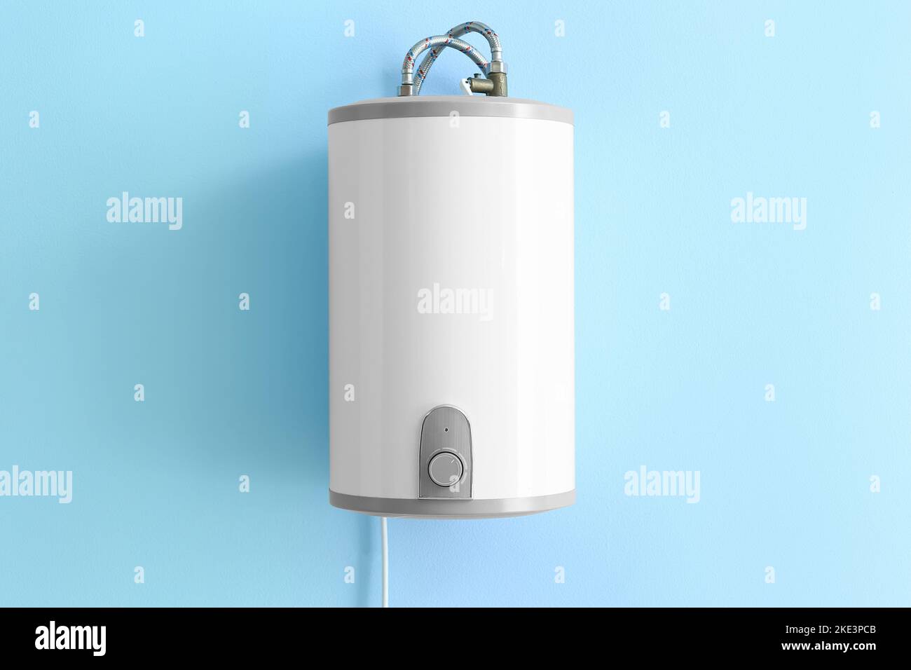 Modern electric boiler on blue wall Stock Photo - Alamy
