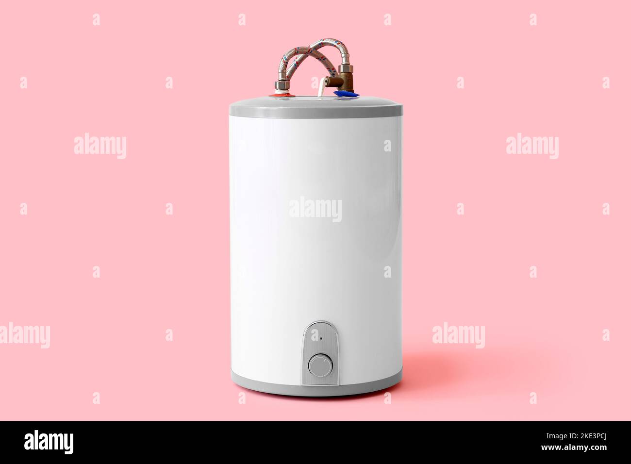 Modern electric boiler on pink background Stock Photo - Alamy
