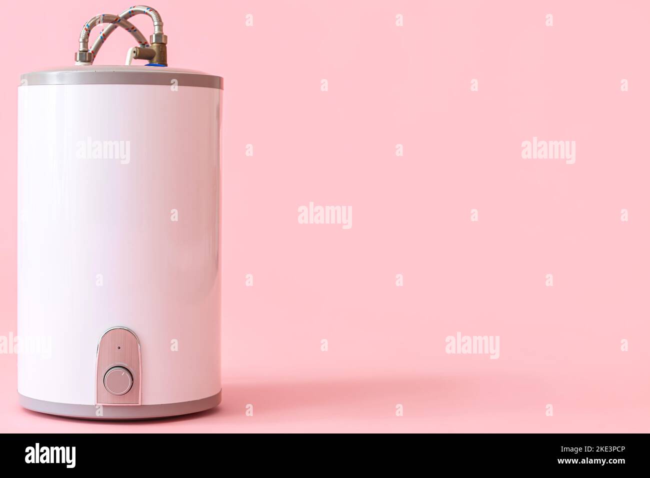 Modern electric boiler on pink background Stock Photo - Alamy