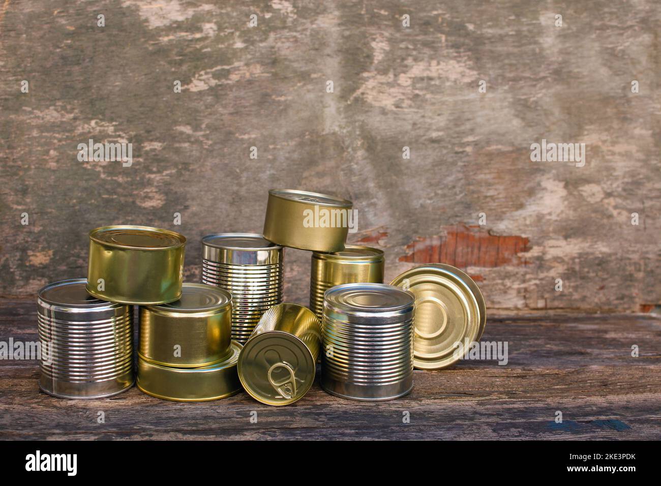 Different closed canned food on old wooden background Stock Photo - Alamy