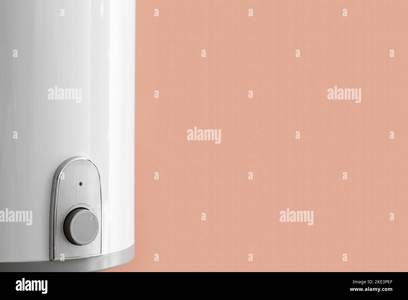 Modern electric boiler on color wall, closeup Stock Photo - Alamy