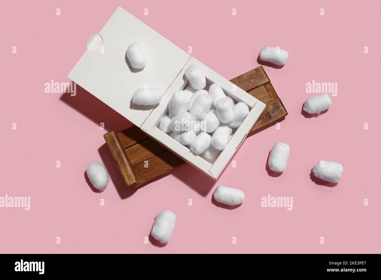 Box with cotton balls on pink background Stock Photo - Alamy