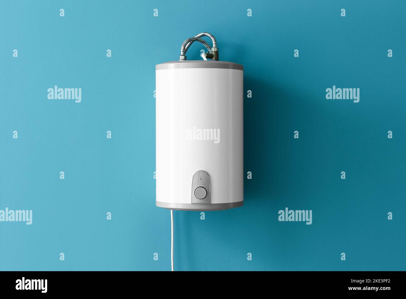 Modern electric boiler on blue wall Stock Photo - Alamy