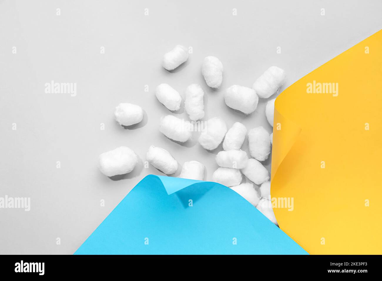 Soft cotton balls and paper sheets on grey background Stock Photo - Alamy