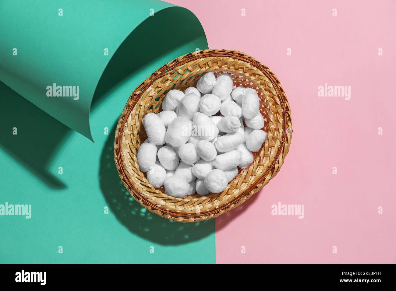 Wicker basket with soft cotton balls on color background Stock Photo ...