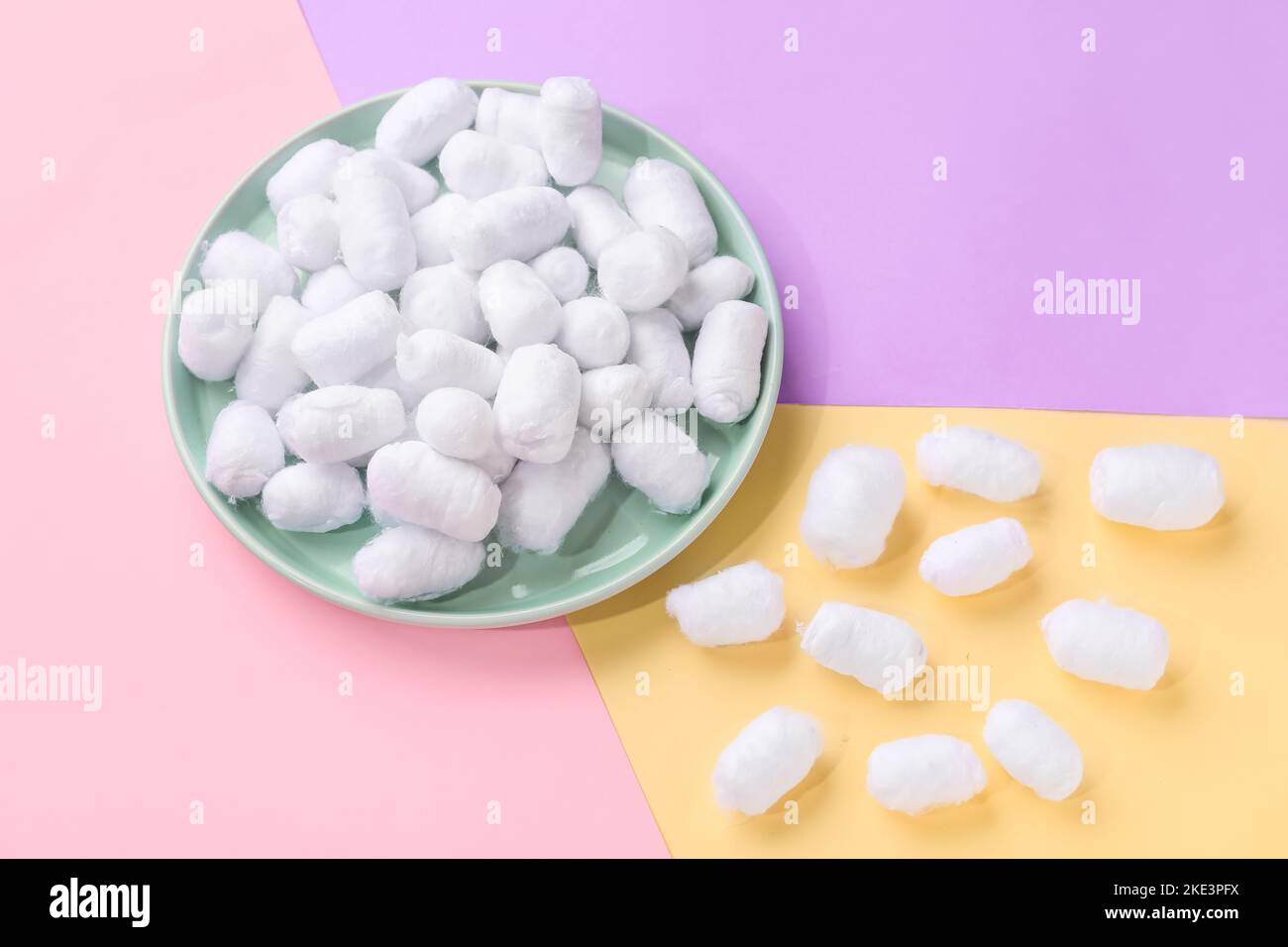 Plate of soft cotton balls on color background Stock Photo - Alamy