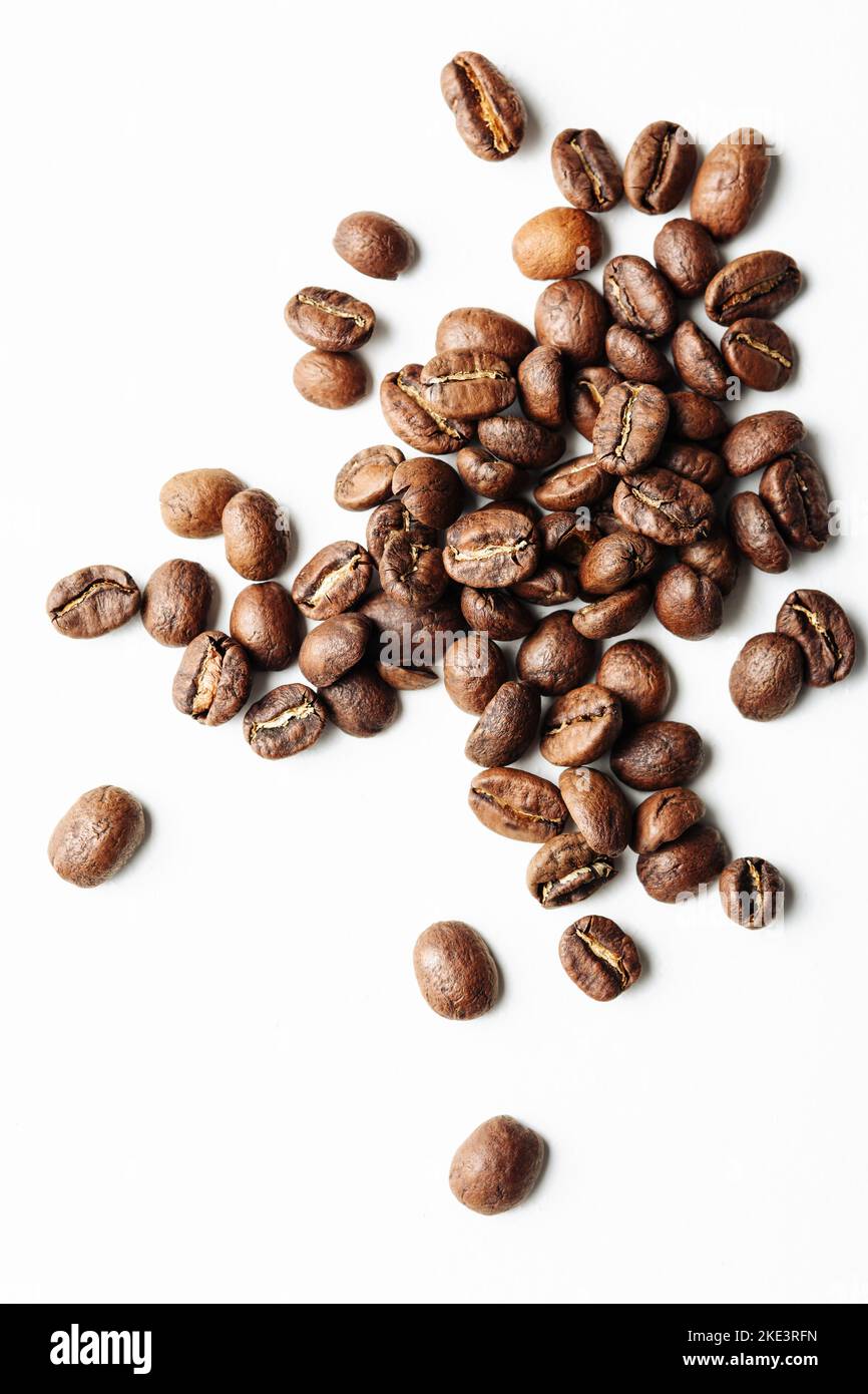 Roasted coffee beans on a white background, close-up Stock Photo - Alamy
