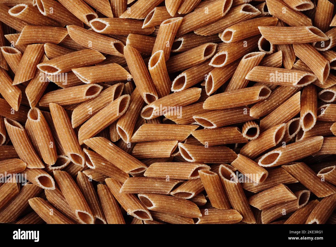 Whole grain penne pasta. Food background Stock Photo - Alamy