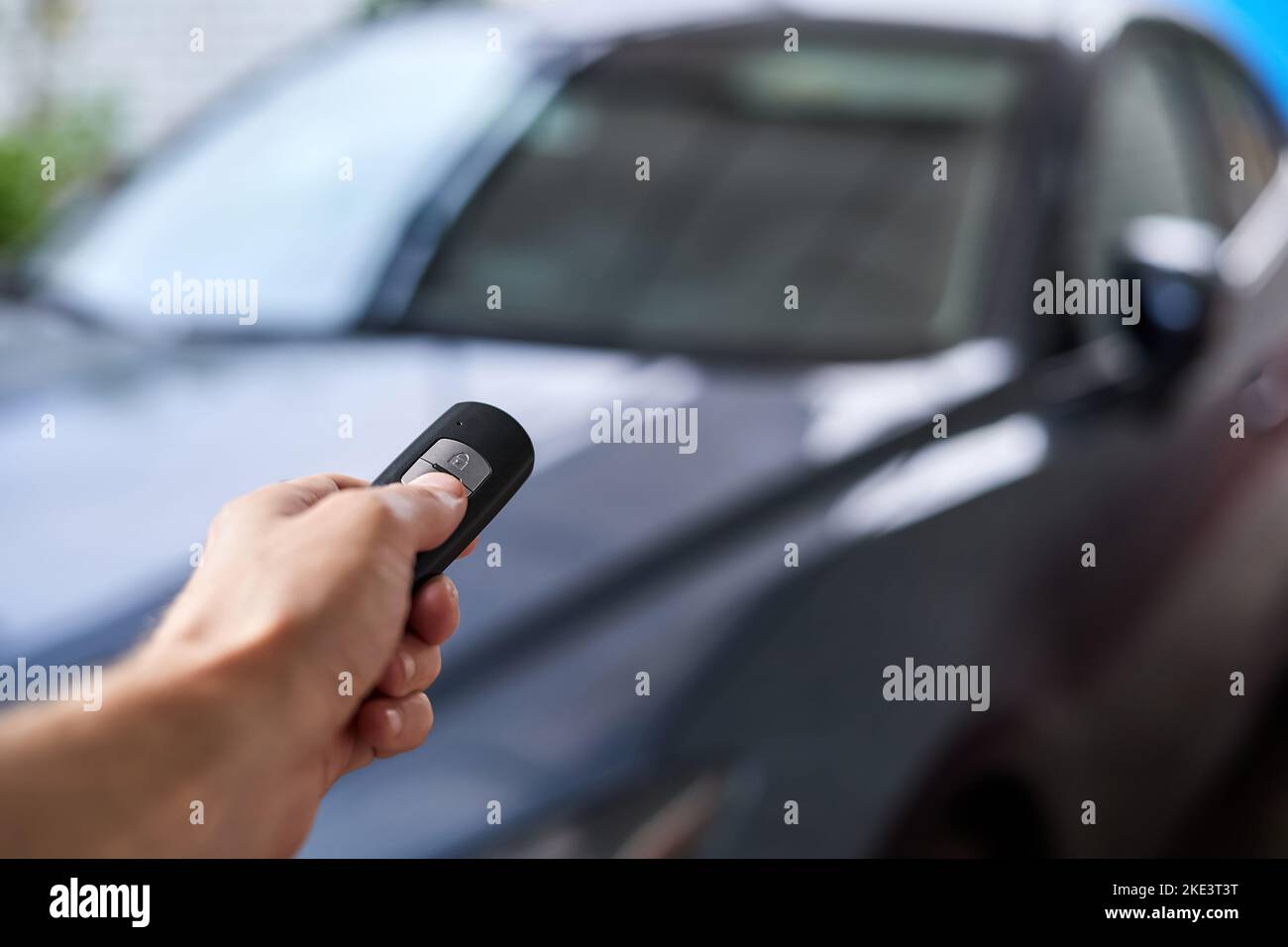 The car owner holds in his hand a remote control device for keyless ...