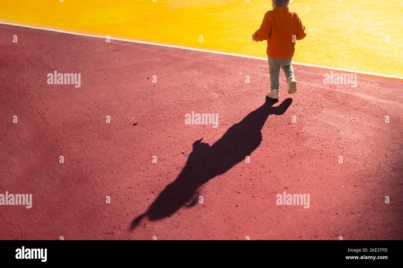 Child playing and running on a colorful playground Stock Photo - Alamy